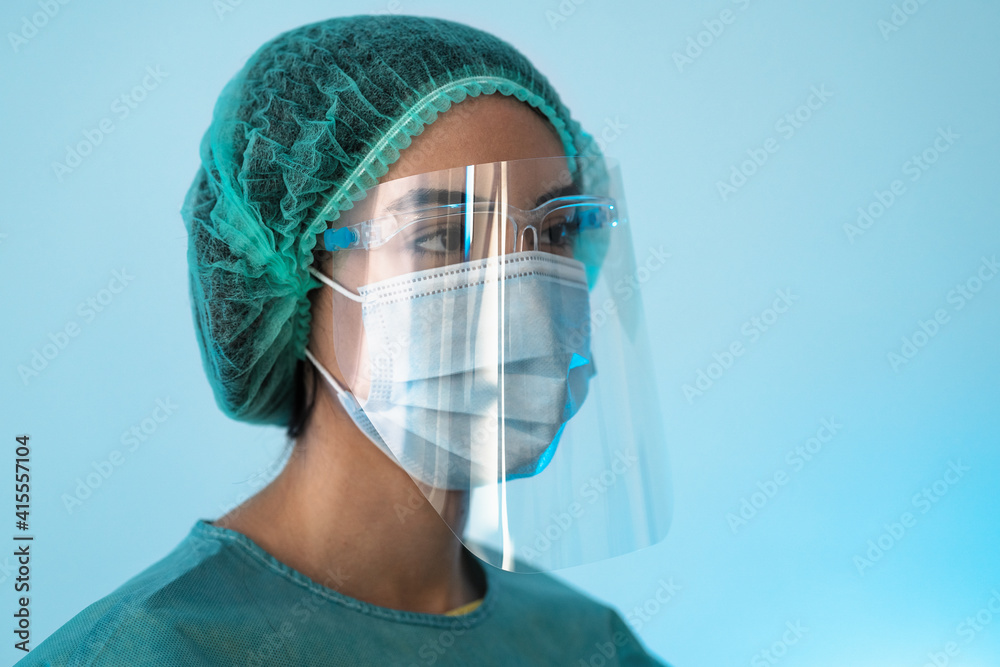 Young female doctor wearing personal protective equipment during corona ...
