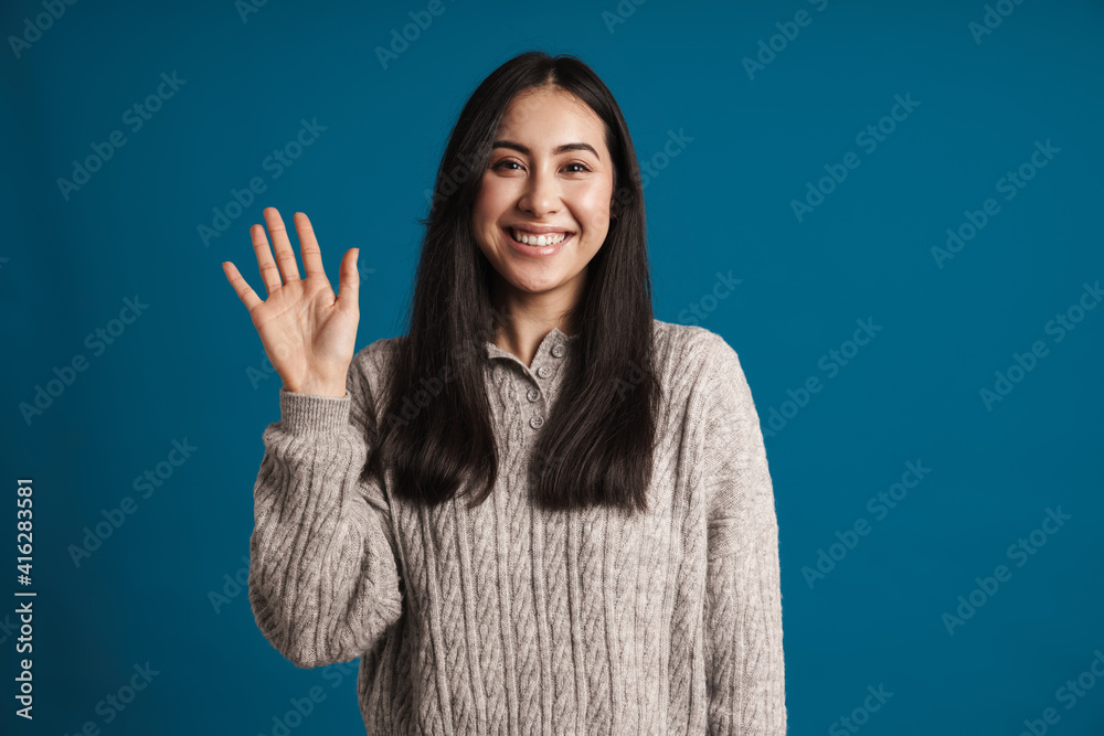 Cheerful lovely girl waving to camera isolated Stock Photo | Adobe Stock
