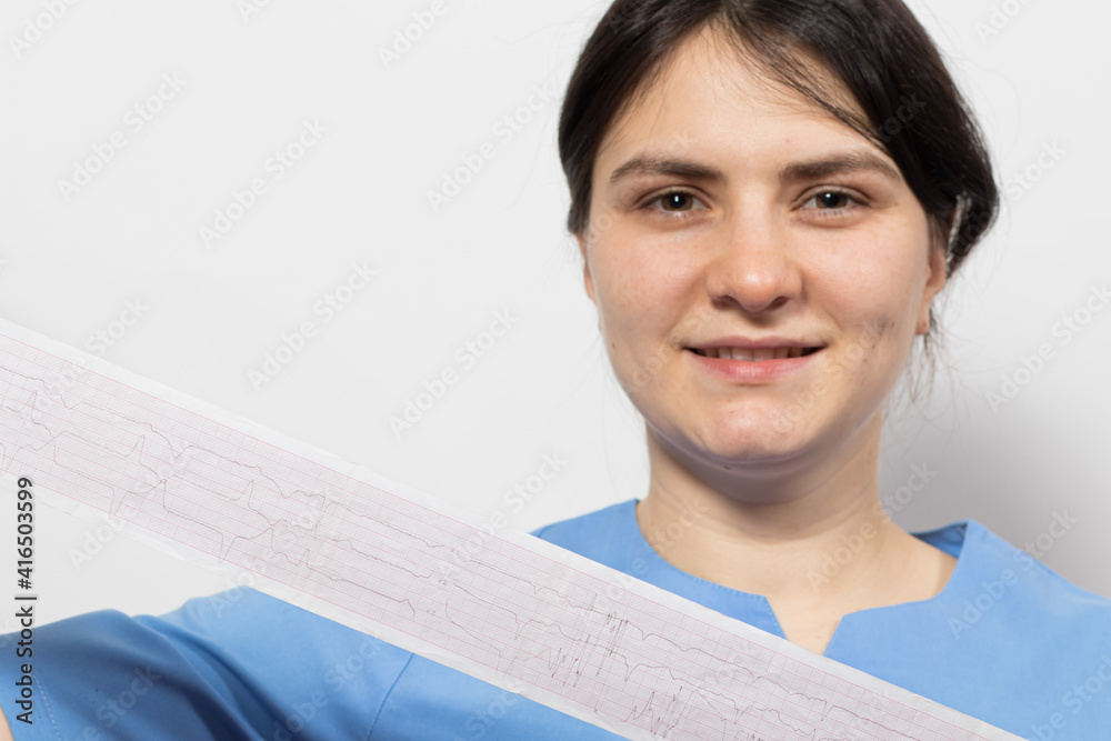 The cardiologist shows the film of an electrocardiogram of a patient ...