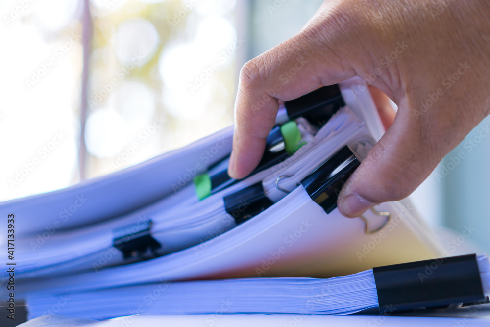Stacks documents of paper files, Businessman hands working in messy ...