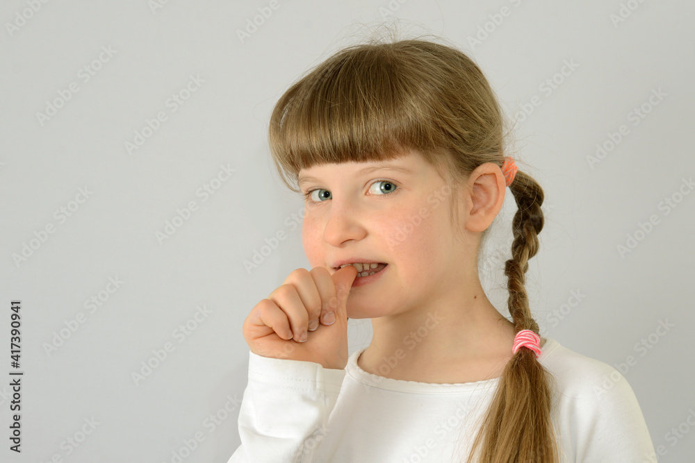 beautiful little girl ( kid child ) bites her fingernails Stock Photo ...