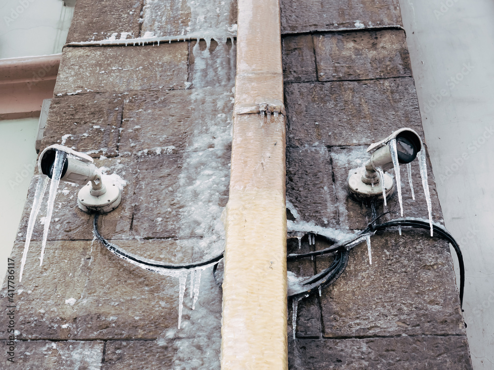 Snow covered frozen CCTV monitor cameras with icicles Stock Photo ...