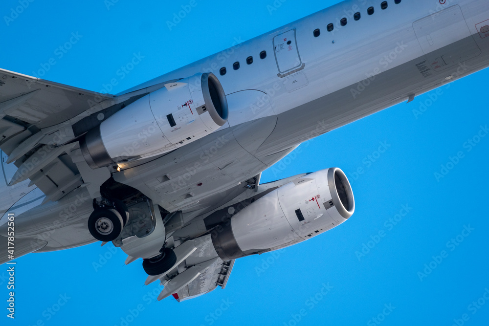 A closeup of a jet-engine with the sun casting reflections from the ...