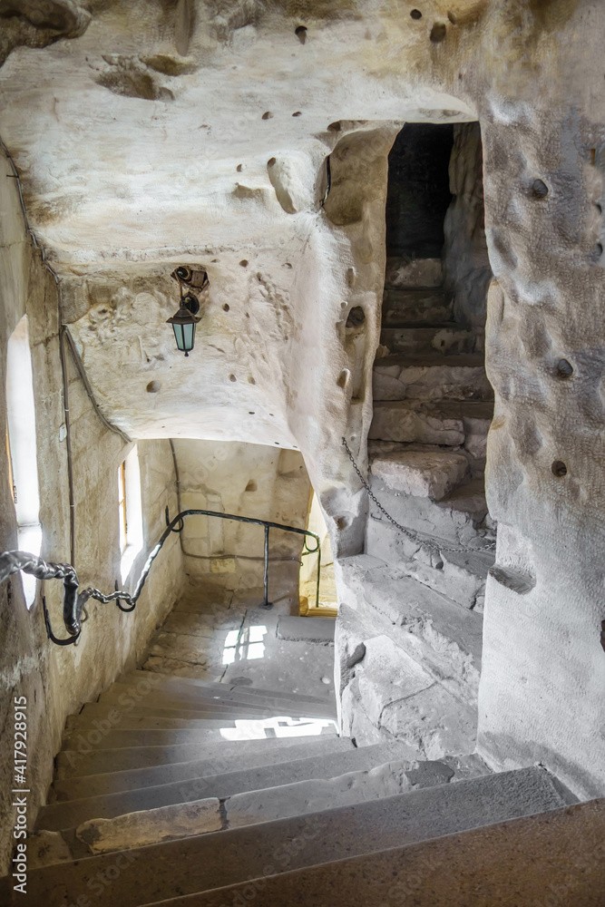 Inner passage inside ancient cave Christian monastery. There are stairs ...