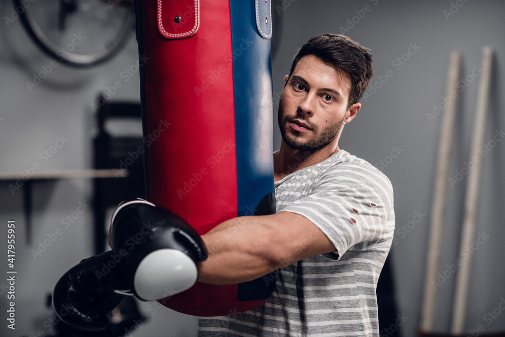 an athlete boxer poses for a photo session in the hall where he is ...