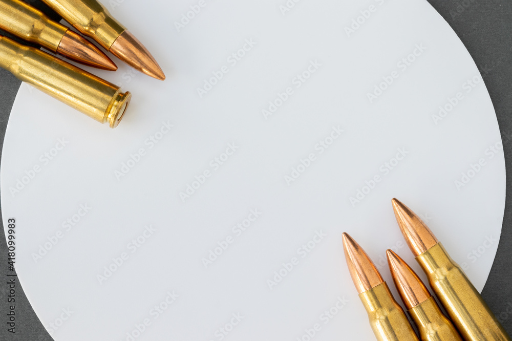 Bullets at corners of white circle on gray paper background. Cartridges ...