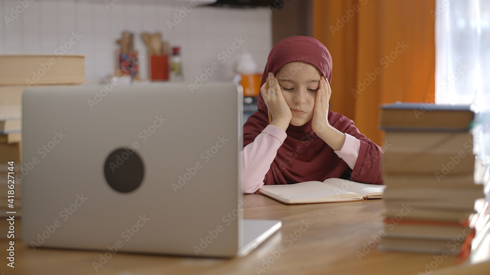 Little girl in a turban tired of being at home and learning from ...