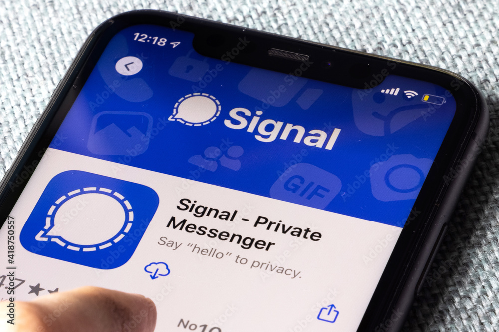 iPhone 11 on blue background with new messenger app Signal logo and ...