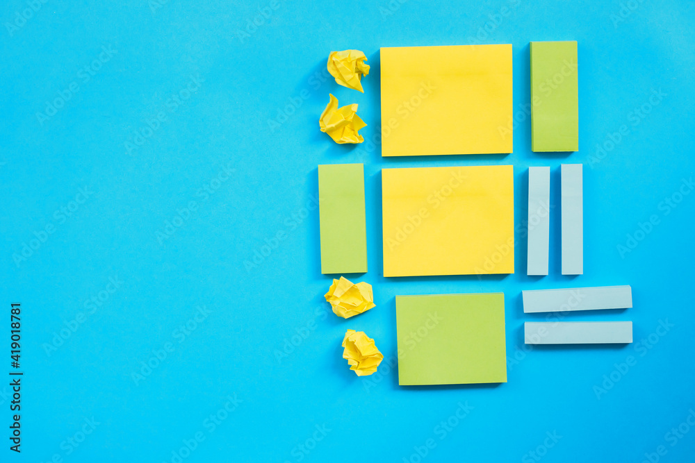 Stickers for entries of different sizes and colors are placed on a blue ...