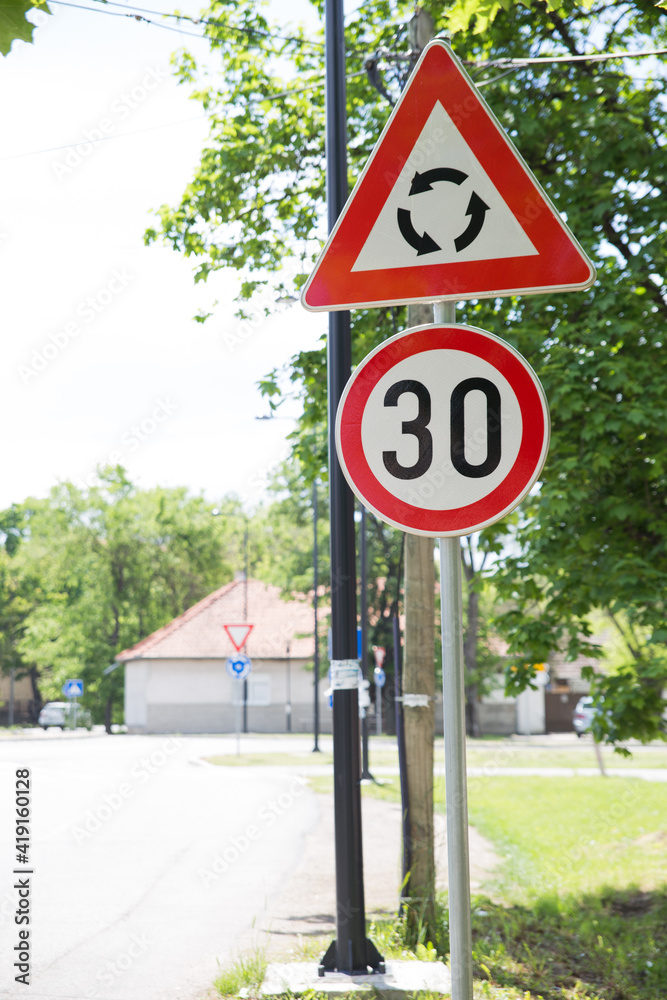 Street traffic sign meaning roundabout and 30 speed limit in traffic ...