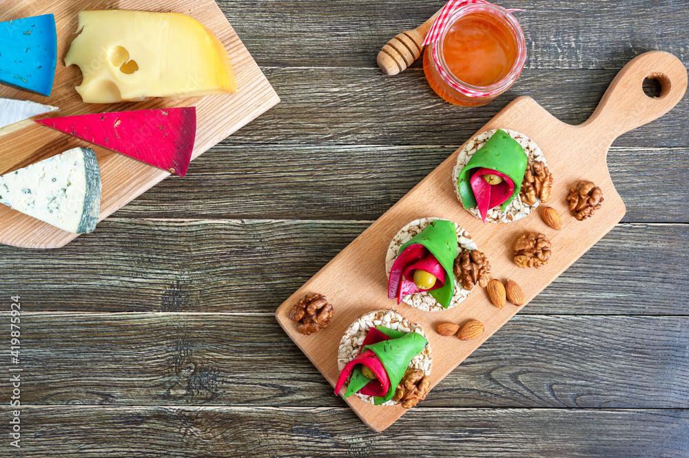 Tasty and healthy canapes with craft cheese, olives, nuts and whole ...