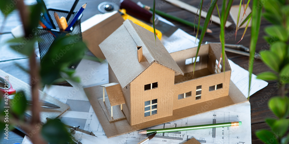 Workplace of architect - construction drawings, scale model and tools ...