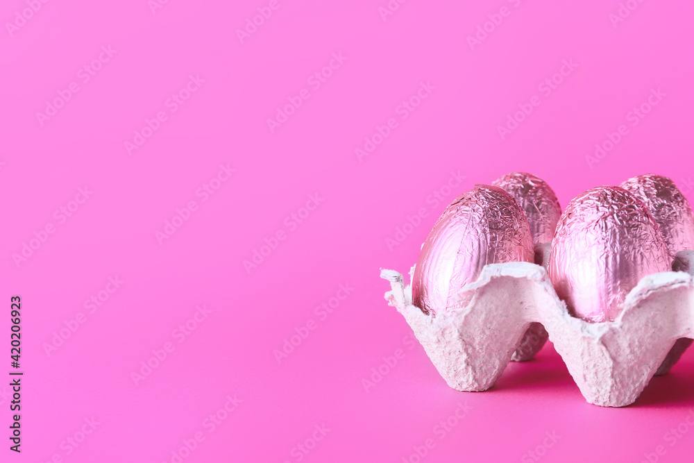 Package with chocolate Easter eggs on color background Stock Photo ...
