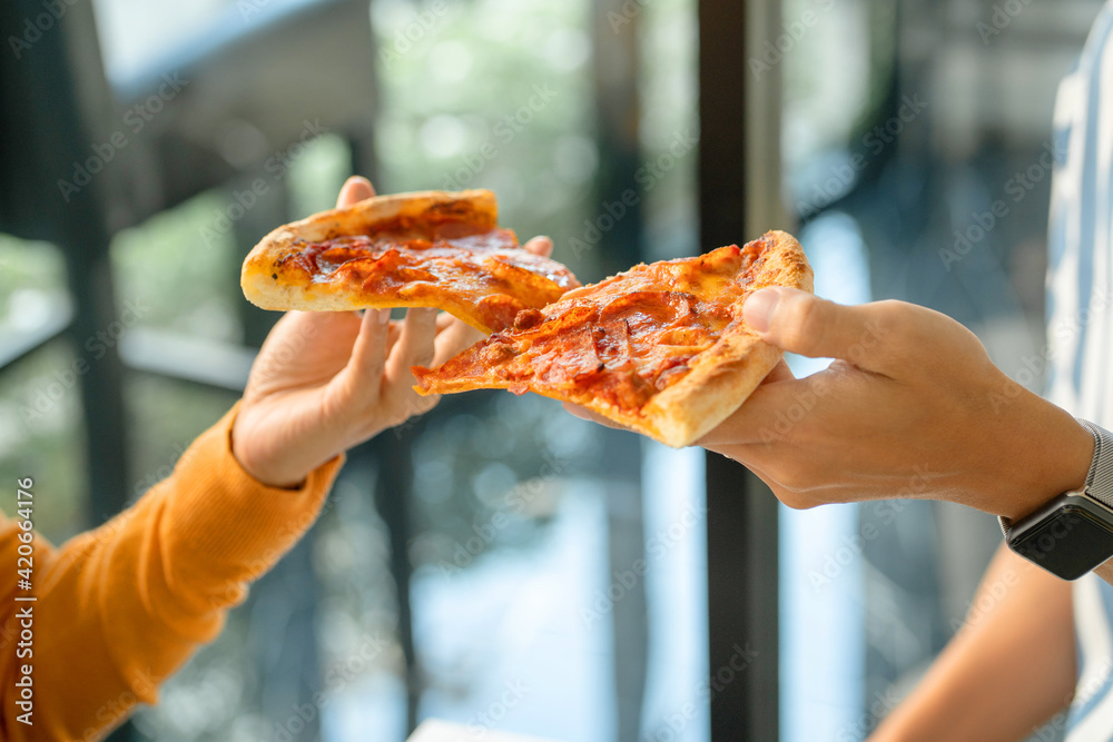 Hands holding slice of pizza having party at home.. Stock Photo | Adobe ...