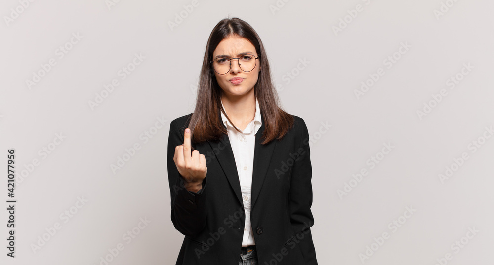 young business woman feeling angry, annoyed, rebellious and aggressive ...