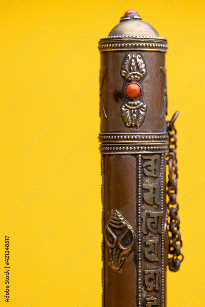 Red dot on the top of a richly decorated metallic silver brown incense ...