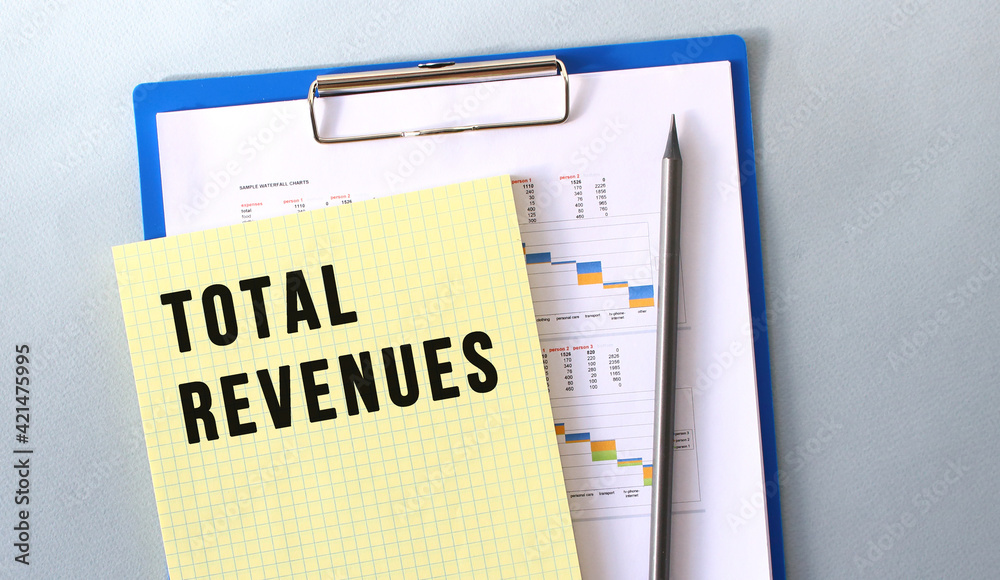 Fotografie TOTAL REVENUES text written on notepad with pencil. Notepad ...