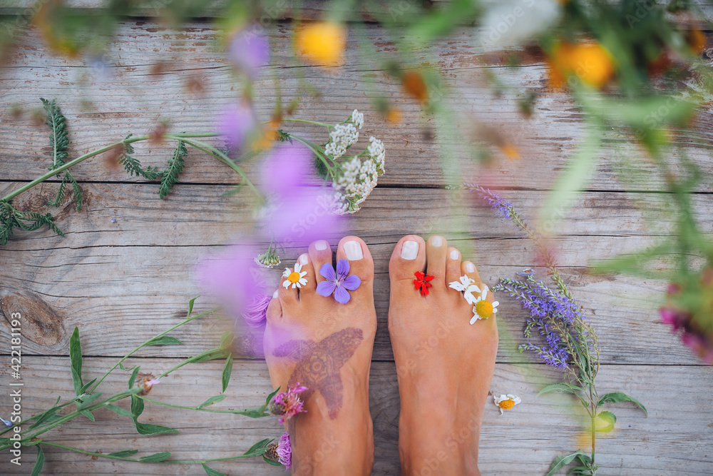 Summer lifestyle portrait of a attractive girl's feet with buds of ...