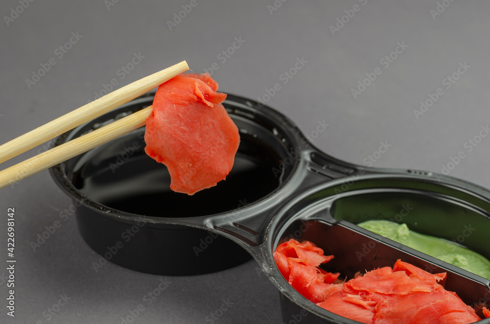 Disposable plastic container with sushi sauces and bamboo sticks Stock ...