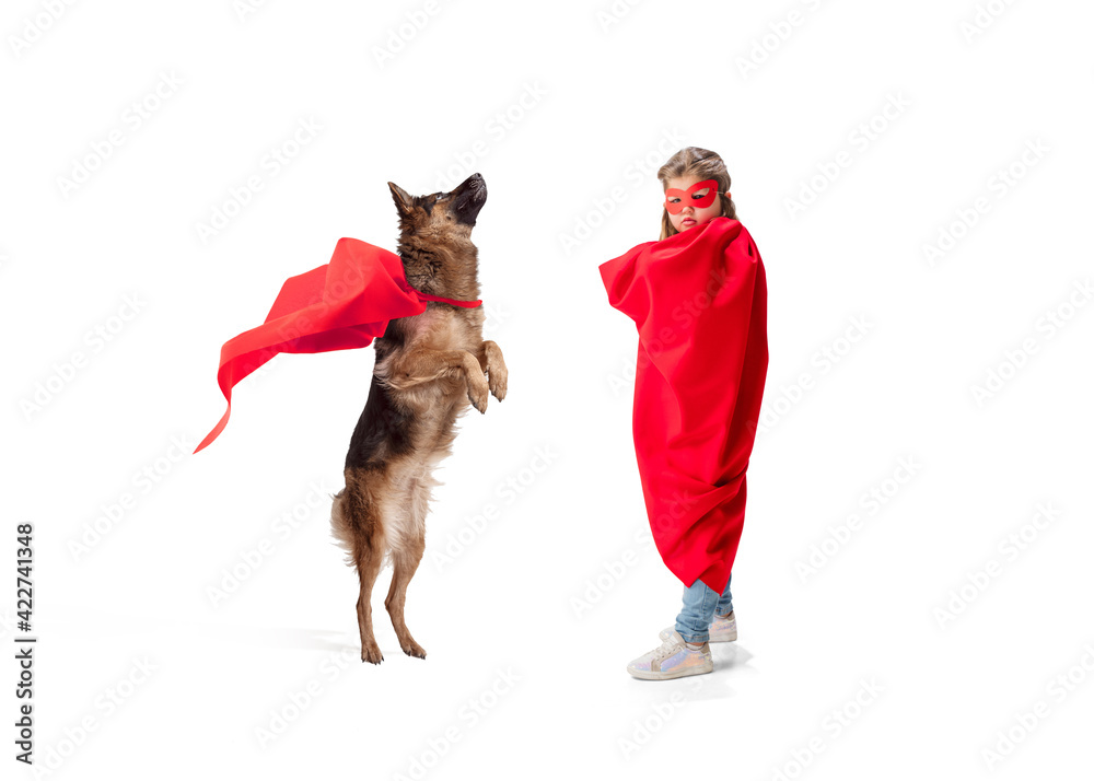 Child pretending to be a superhero with her super dog isolated on white ...