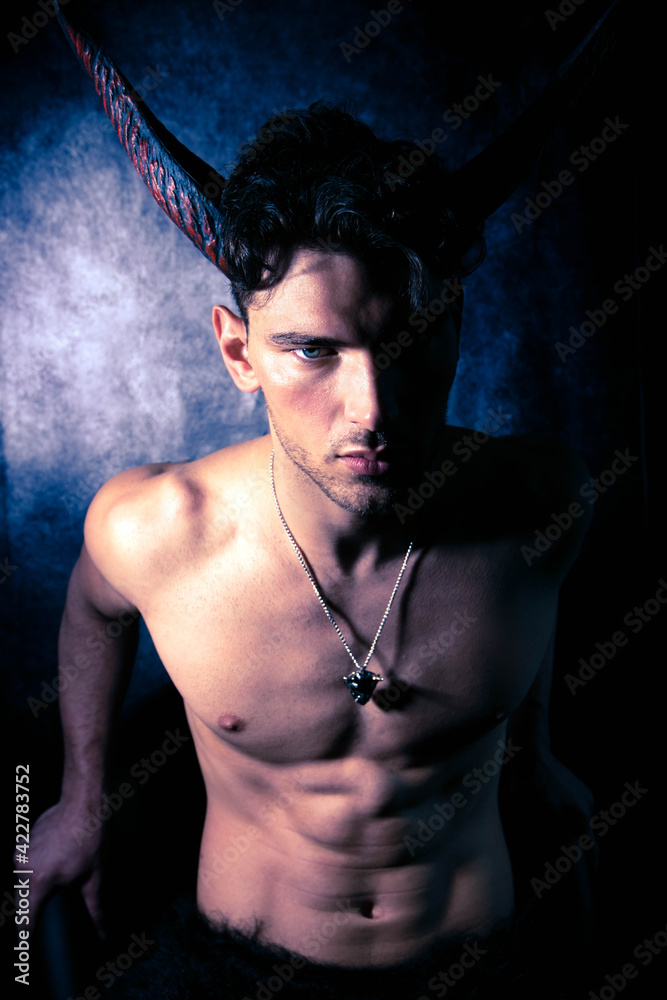 Sexy shirtless male devil with horns and muscular body showing pecs and ...