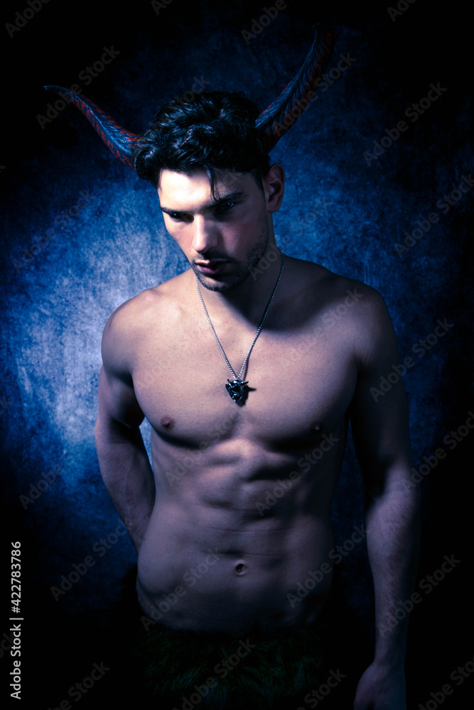 Sexy shirtless male devil with horns and muscular body showing pecs and ...