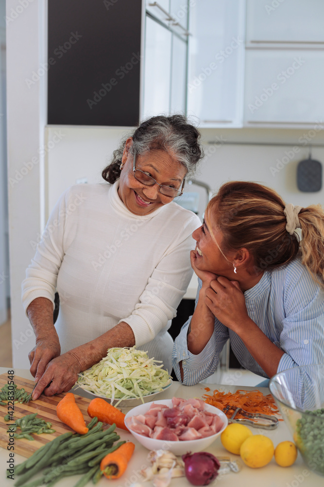 Photo Stock Filipino family cooking together at home - Granddaughter ...