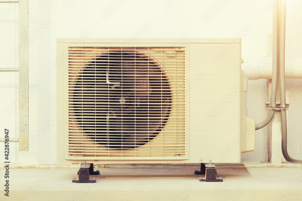 Condenser unit or compressor outside home or residential building. Unit ...