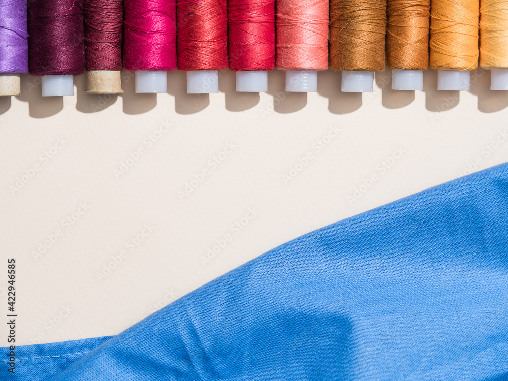 Spools of colored thread are lying side by side. Sewing thread ...