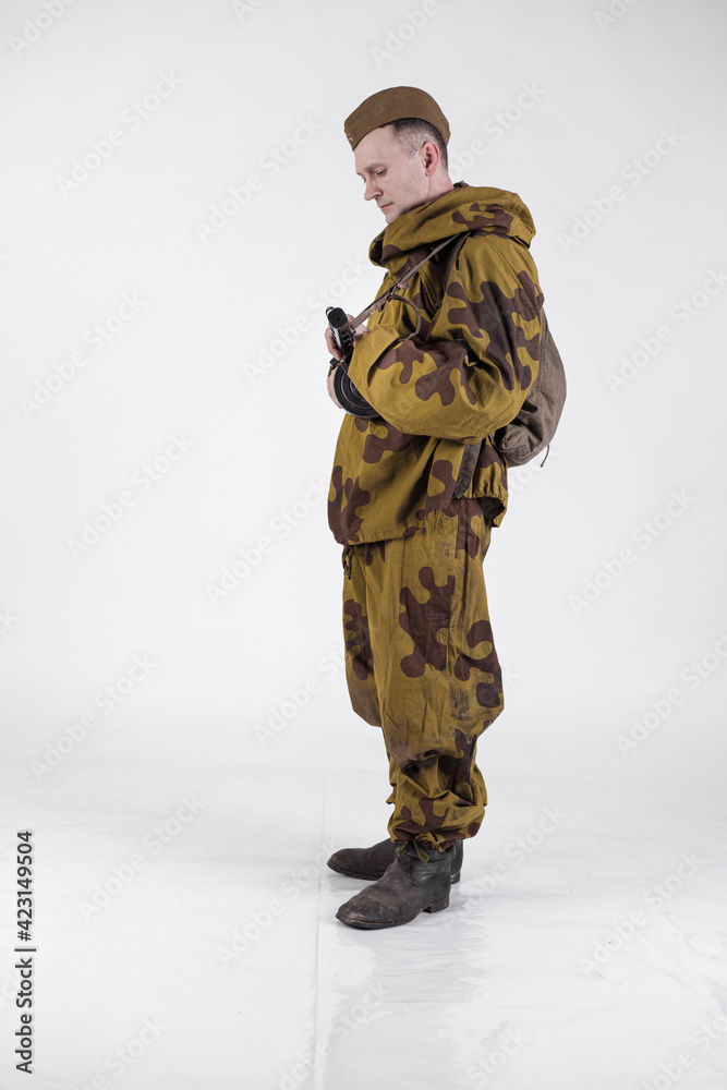 Actor man in an old military uniform and camouflage sniper marksman ...