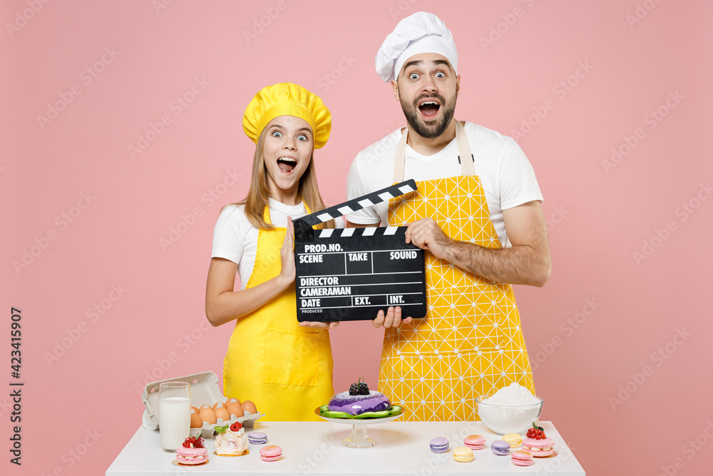 Teen shock girl dad chef cook confectioner baker in apron cap at table ...