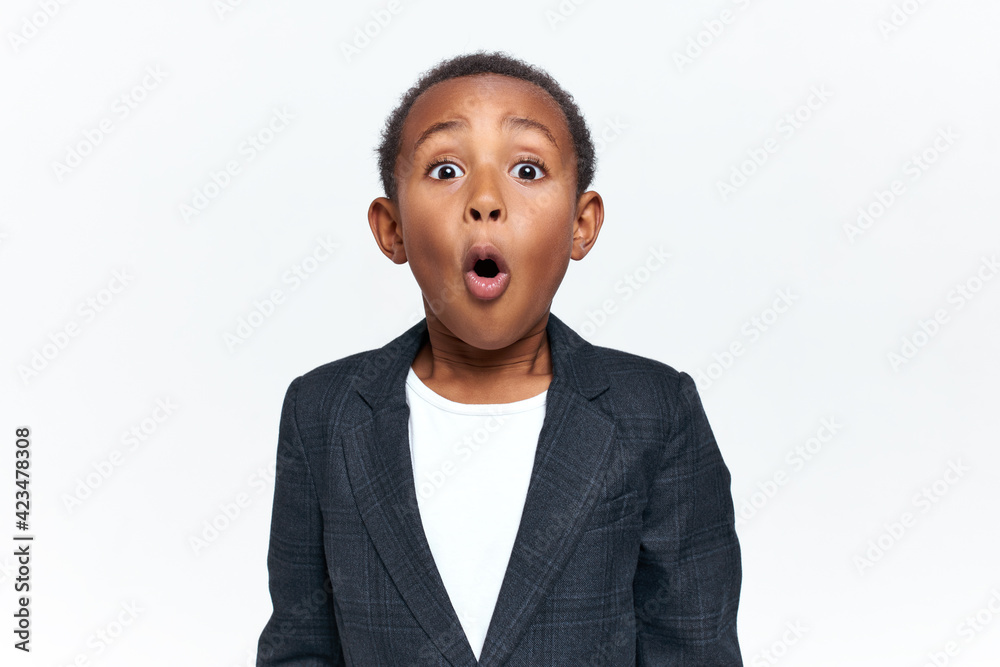 Photo Stock Emotional scared black little boy gasping and raising ...