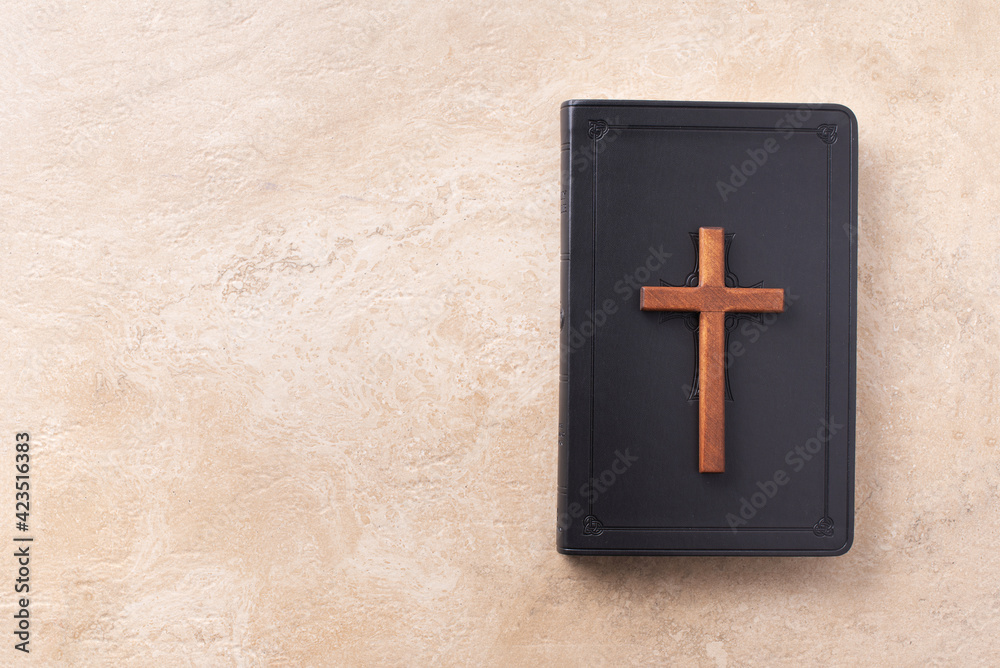 Wooden cross on Bible over marble background. Reminder of Jesus ...