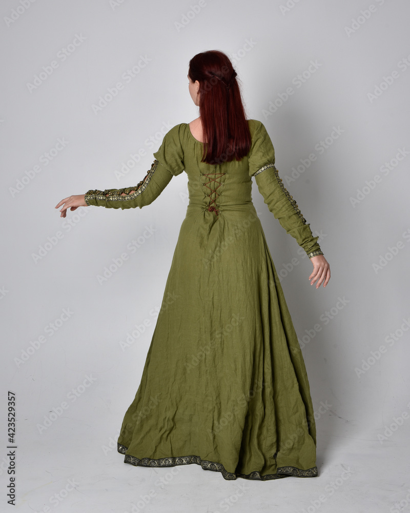 full length portrait of red haired girl wearing celtic, green medieval ...
