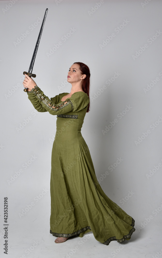 full length portrait of red haired girl wearing celtic, green medieval ...