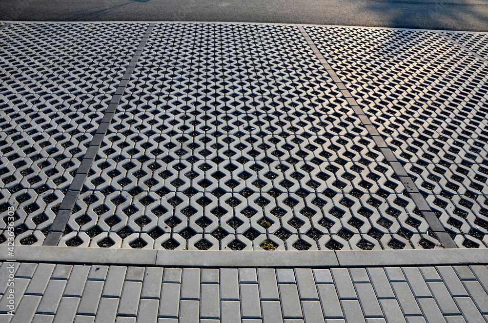 new infiltration parking lot made of porous concrete tiles in a regular ...