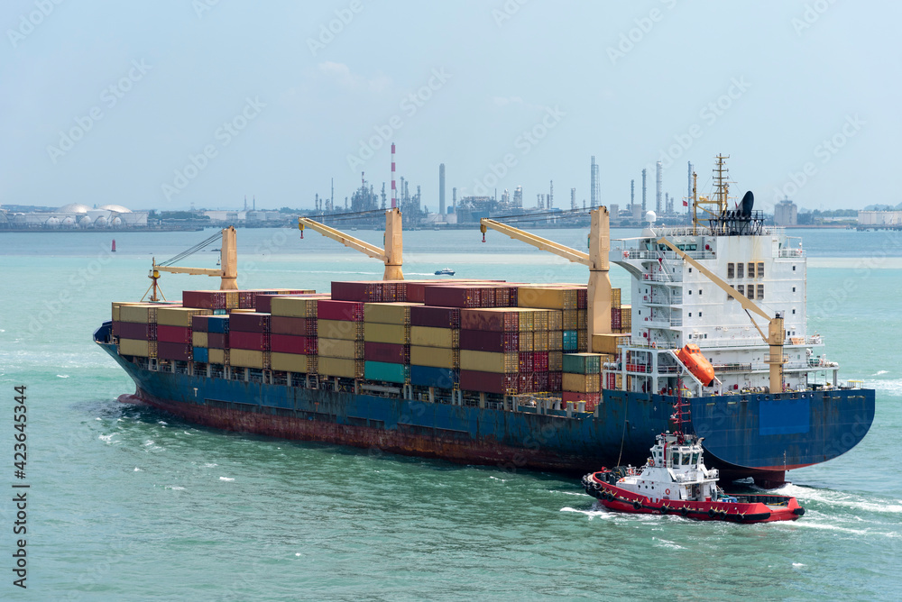 Container ship departing from the cargo terminal in Singapore. Vessel ...