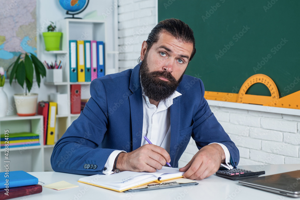 too much work. informal education. male student sit in classroom while ...