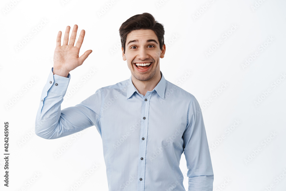Friendly office worker waving hand and saying hello, smiling say hi ...