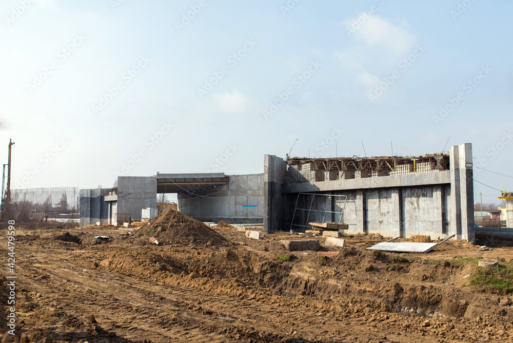 Construction site with new concrete building structure and earthworks ...