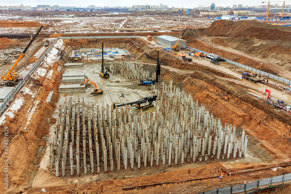 Pile driving in foundation pit for construction of apartment building ...