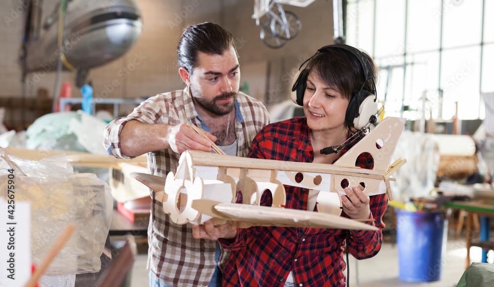 Positive couple enjoying their hobbies - modeling light airplanes in ...