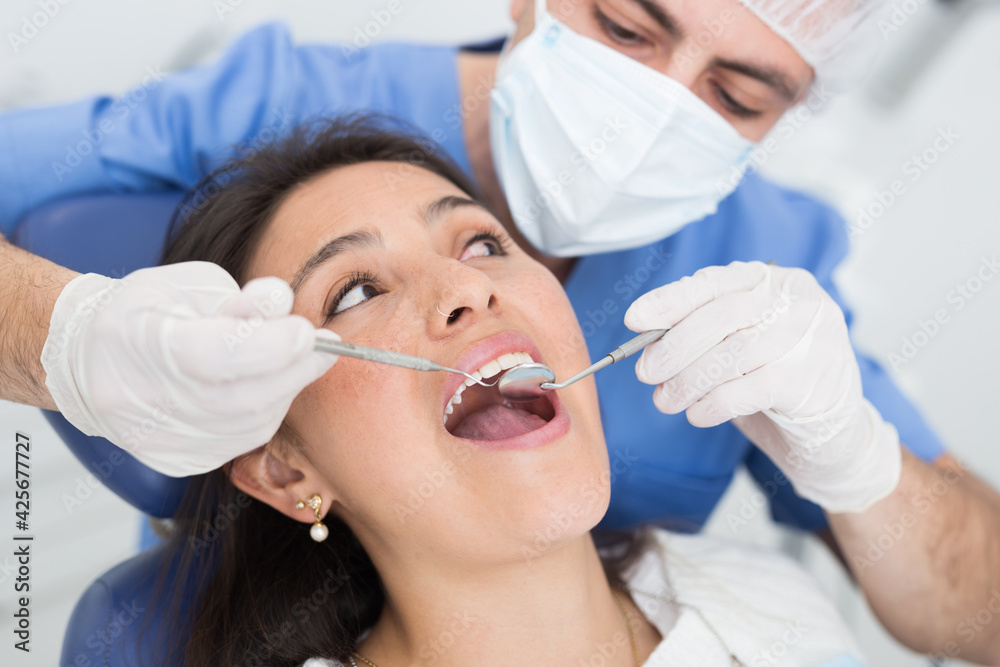Medical checkup oral cavity of female patient with dental instruments ...