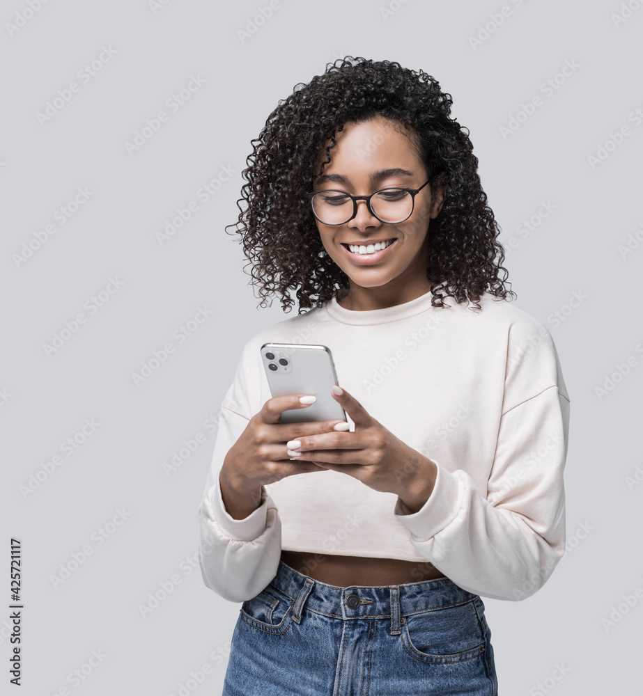 Beautiful young woman looking at phone isolated studio portrait ...