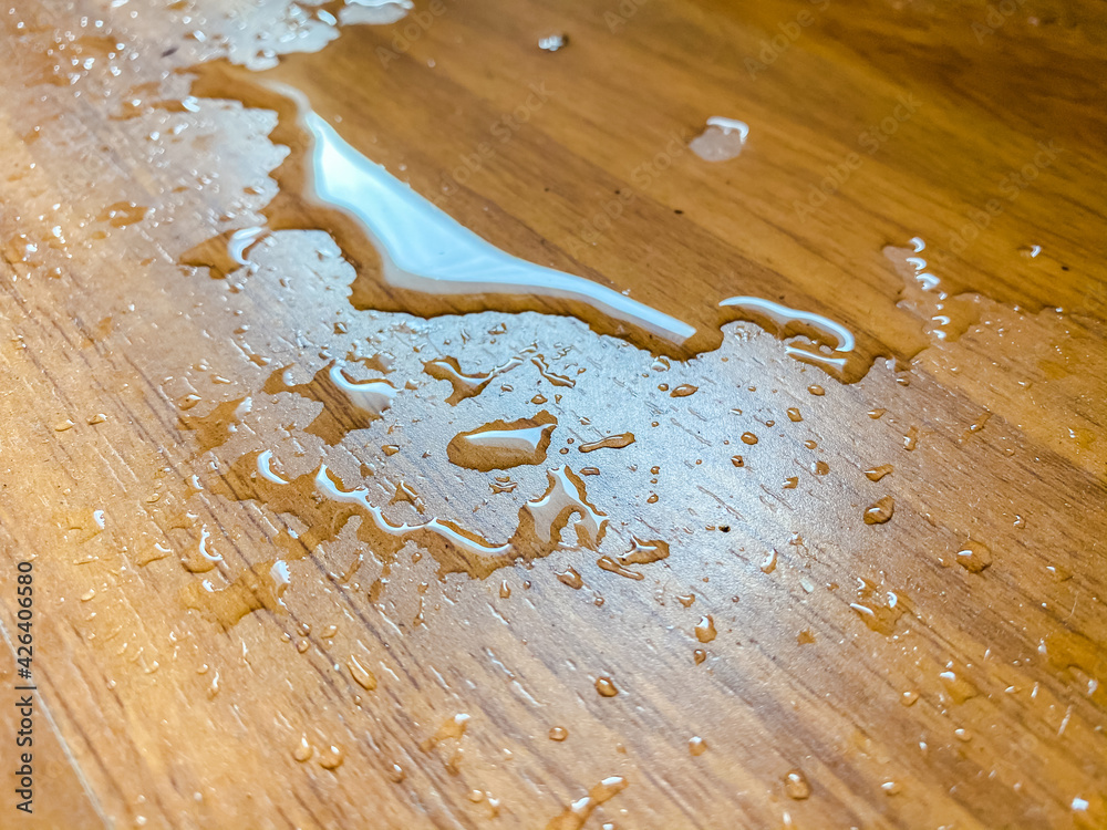 water spill on parquet wood floor, which leaking from air conditioner ...