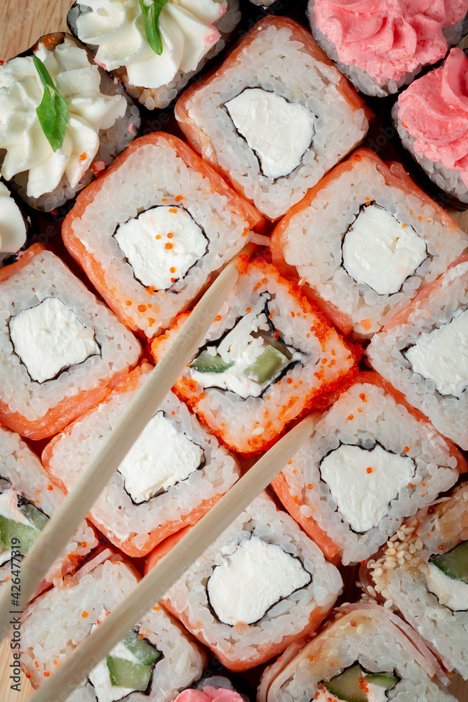 Japanese sushi food. Maki and rolls with tuna, salmon, shrimp, crab and ...