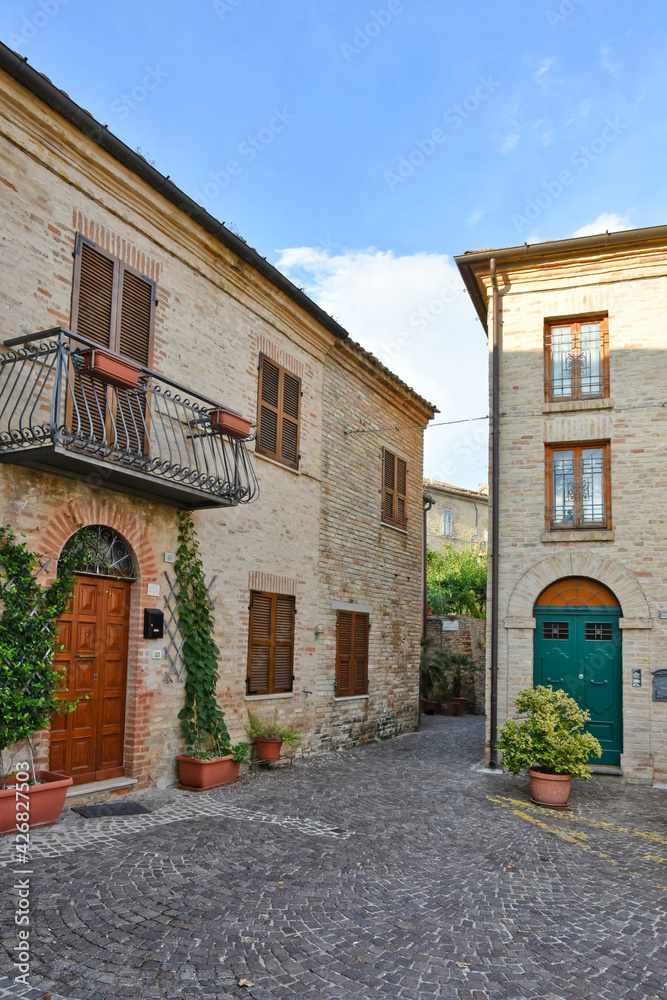 Stock-Foto „A narrow street between the old houses of Civitanova Alta, a medieval town in the ...