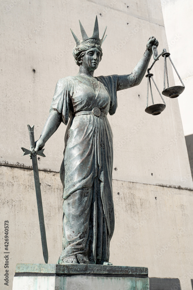 Statue of Lady Justice with the sword in one hand and the scales of ...