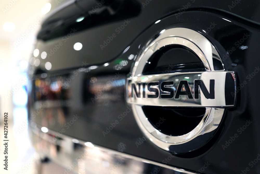 Nissan corporation logo on a car. Nissan Motor Corporation is a ...