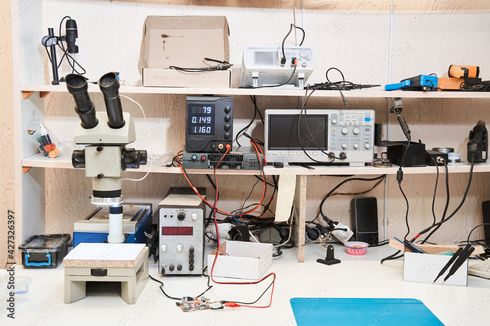 Table at the office or laboratory with microscope and special tools ...